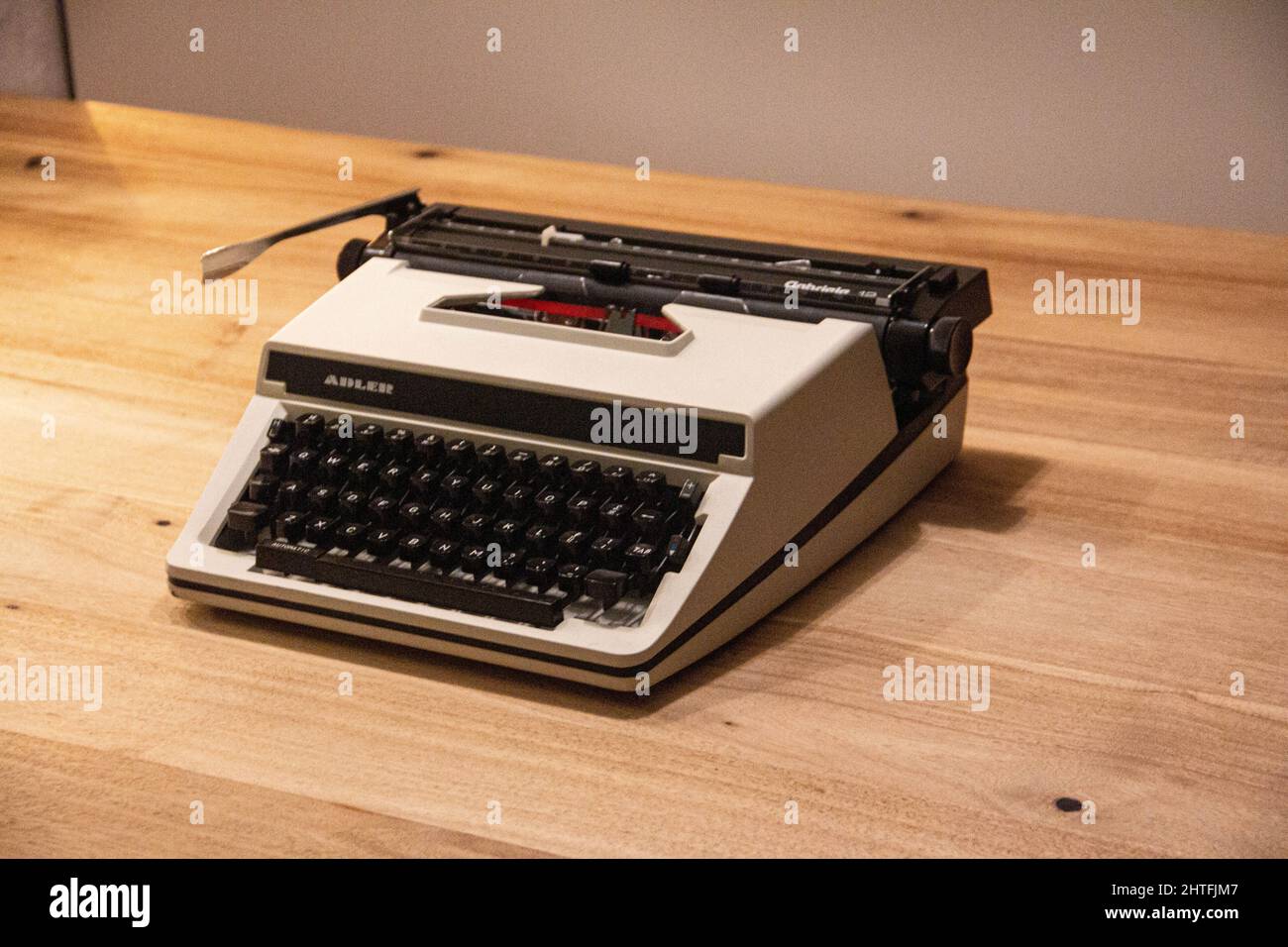 Typewriter from the 1980 on a wooden surface Stock Photo - Alamy
