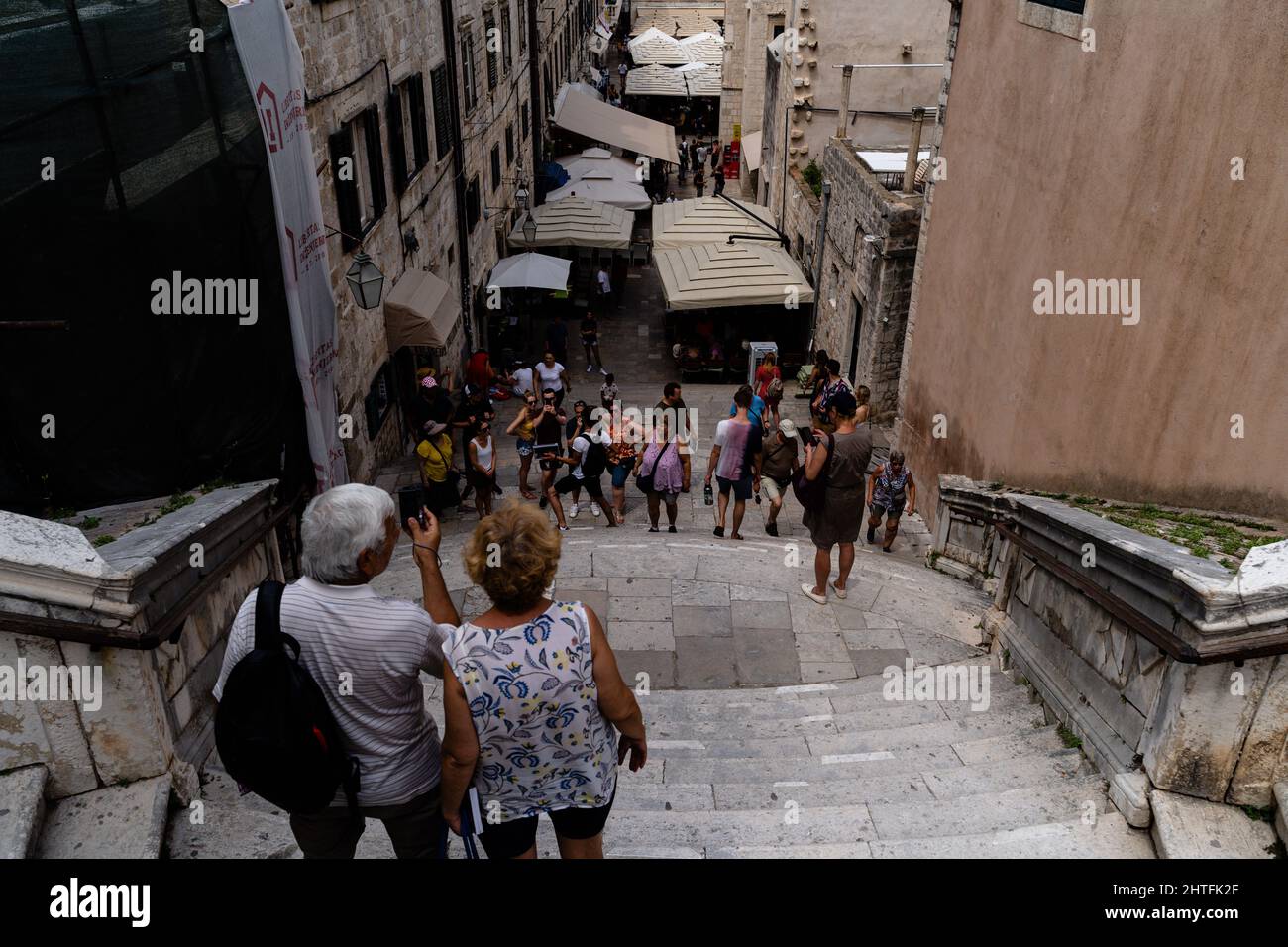 Wide shot of tourists roaming around the city center of Stock Photo - Alamy