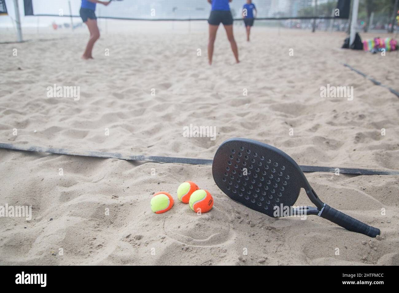 Beach tennis racket and balls on the sand Stock Photo - Alamy
