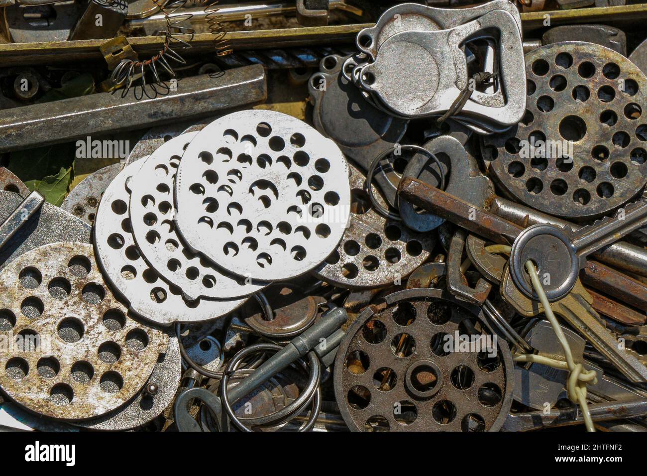 Top view of metal objects; old keys, tools, meat grinder plates. Old ...