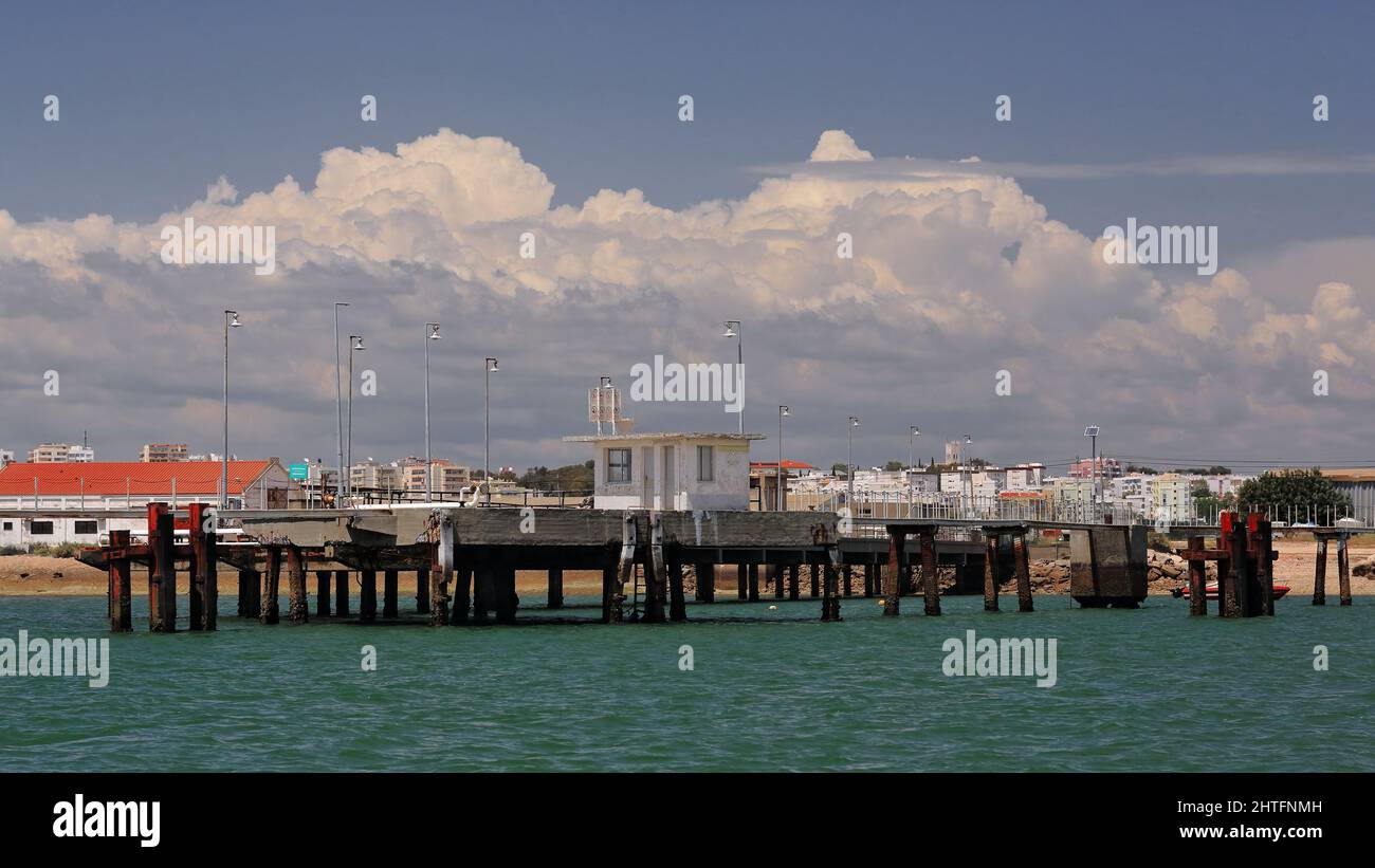 Spoiled jetty with neglected guardhouse at commercial wharf-Ria Formosa ...