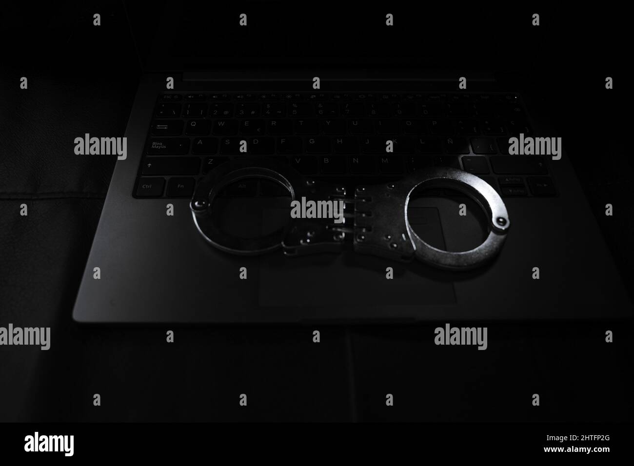 Handcuff on keyboard laptop hi-res stock photography and images - Alamy