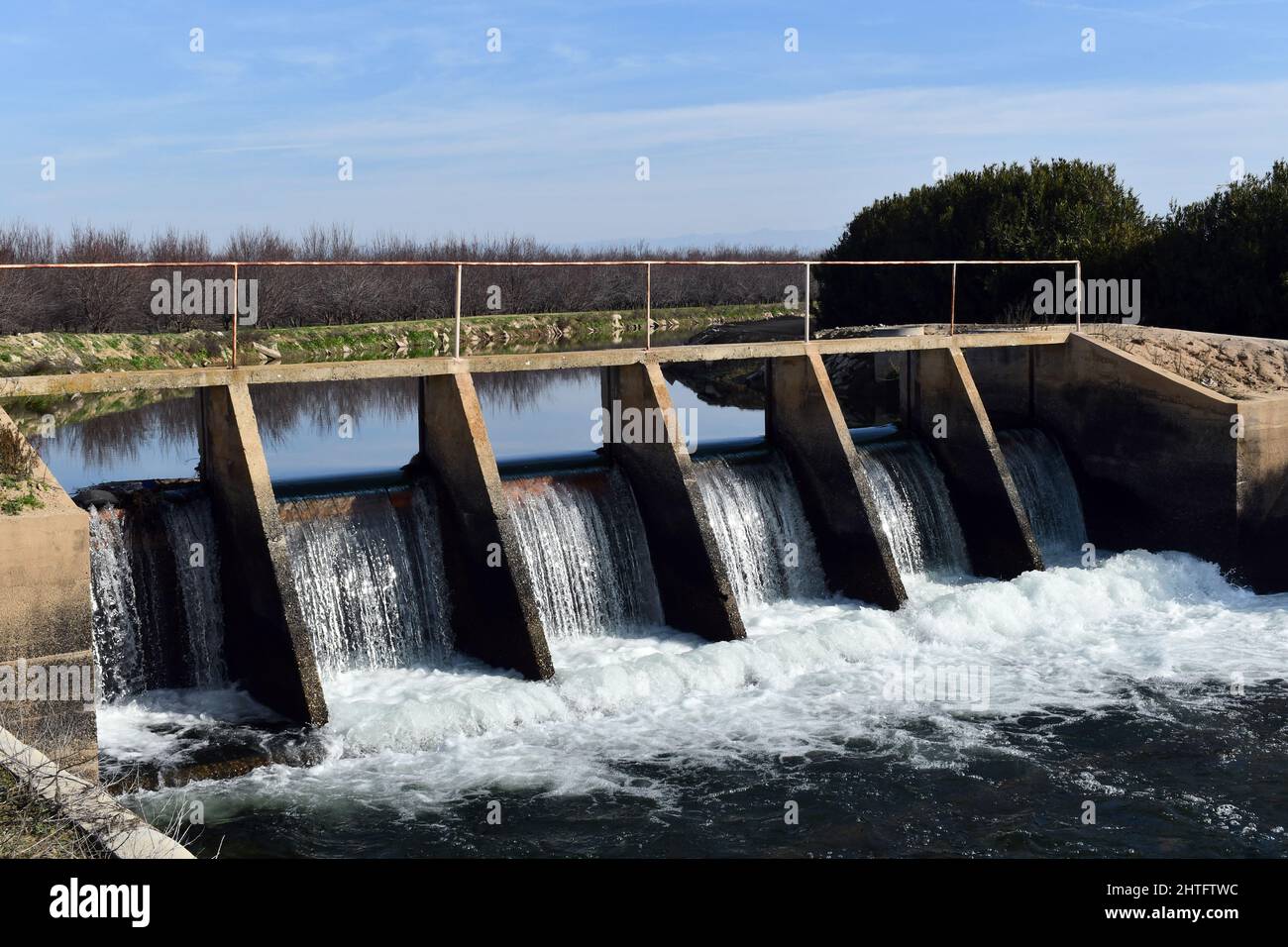 Water splashing through a dam over a river Stock Photo - Alamy