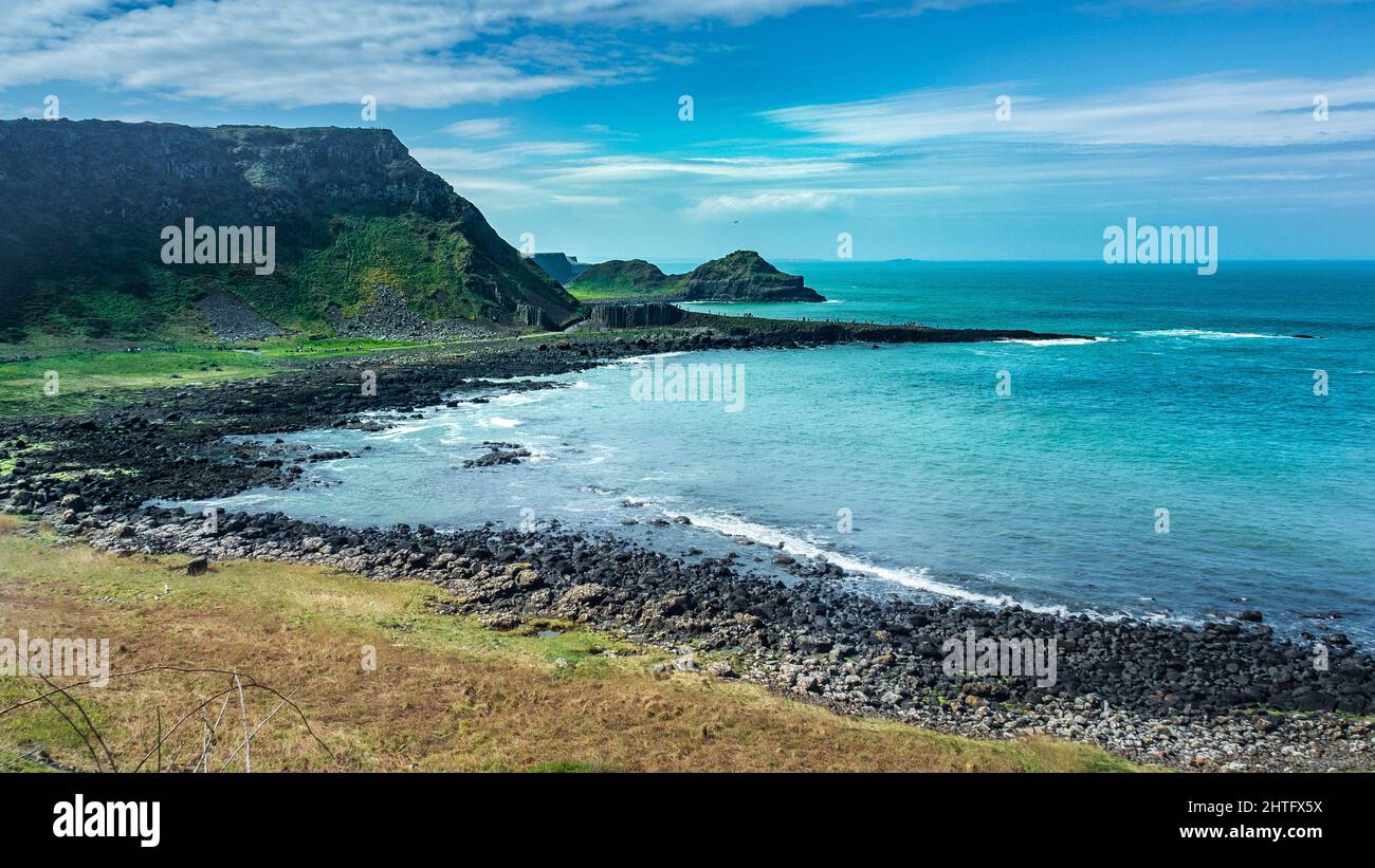 Ocean waves hitting the rocky beach surrounded by cliffs Stock Photo ...