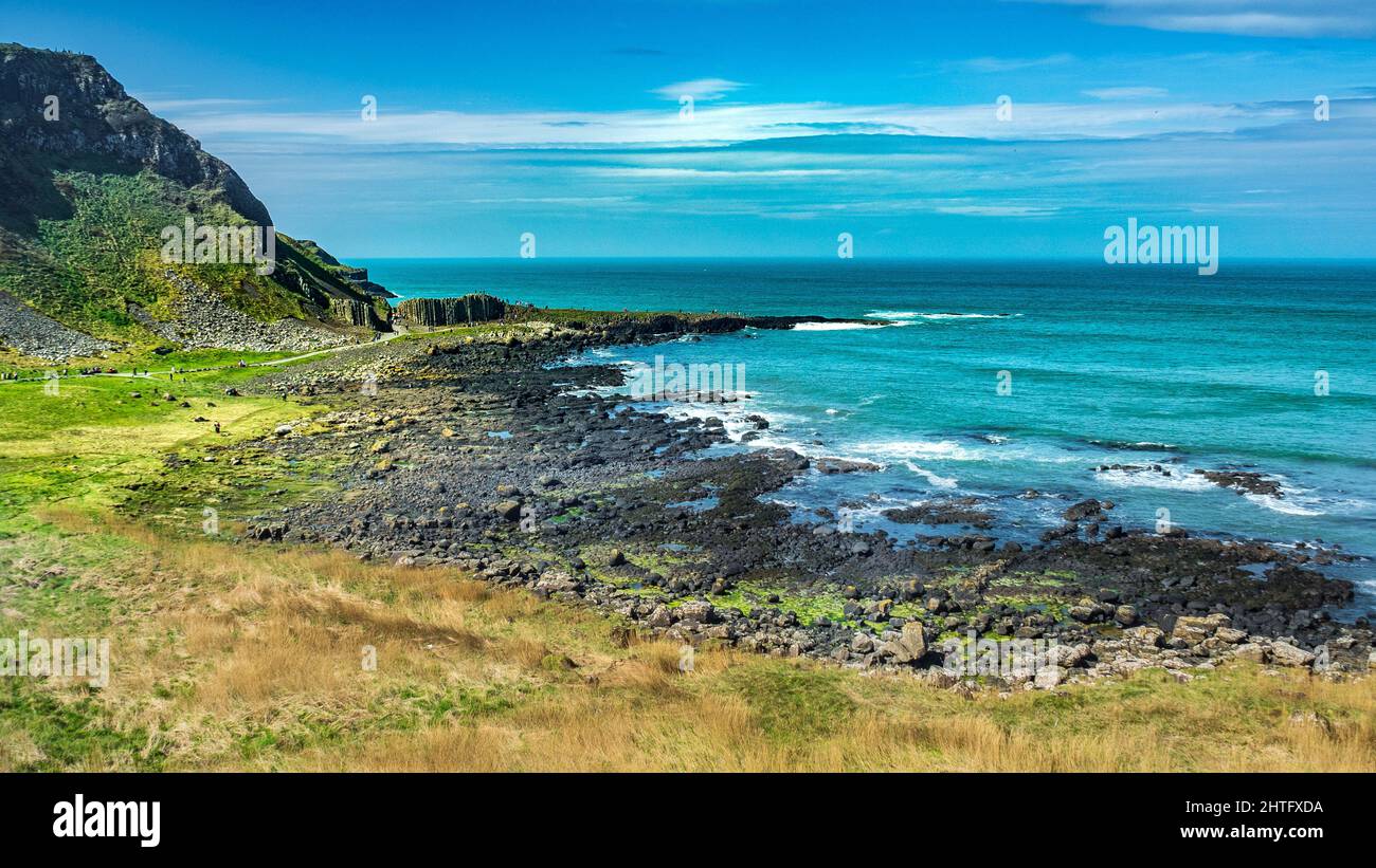Ocean waves hitting the rocky beach surrounded by cliffs Stock Photo ...