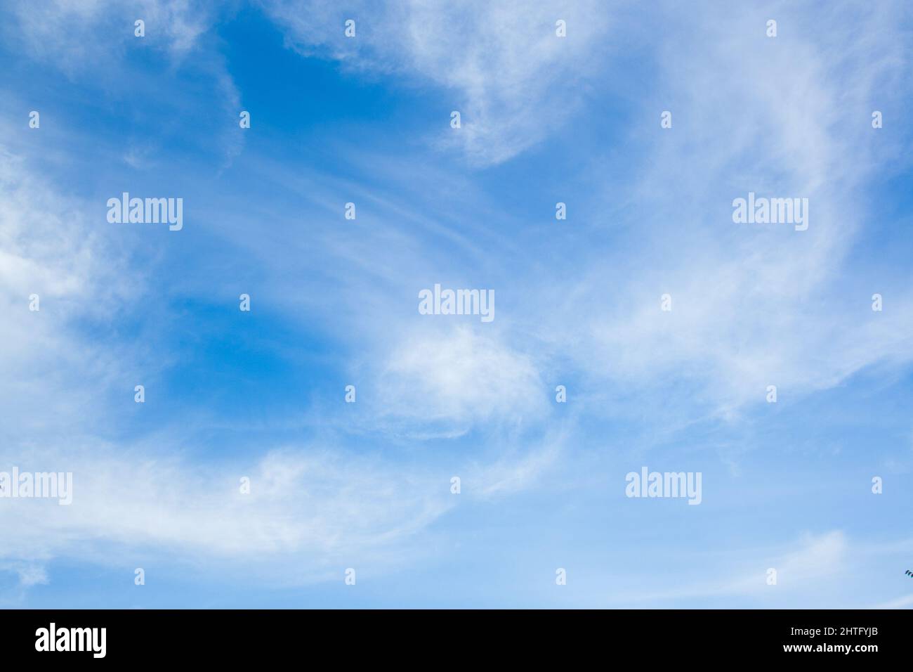 Huge clouds in blue sky lit by the sun, windy day Stock Photo - Alamy
