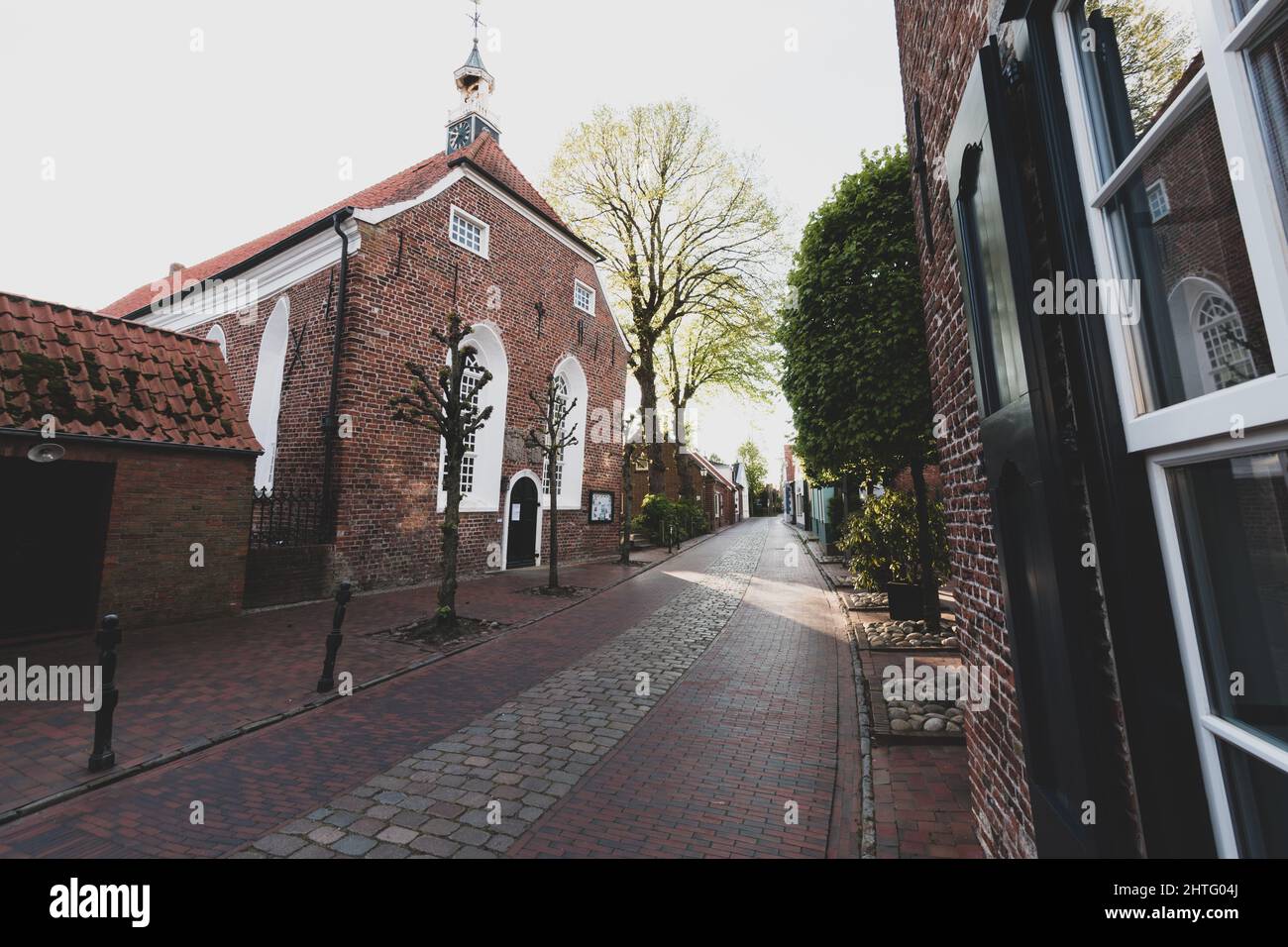 Red brick buildings in the streets of Greetsiel, Germany Stock Photo ...