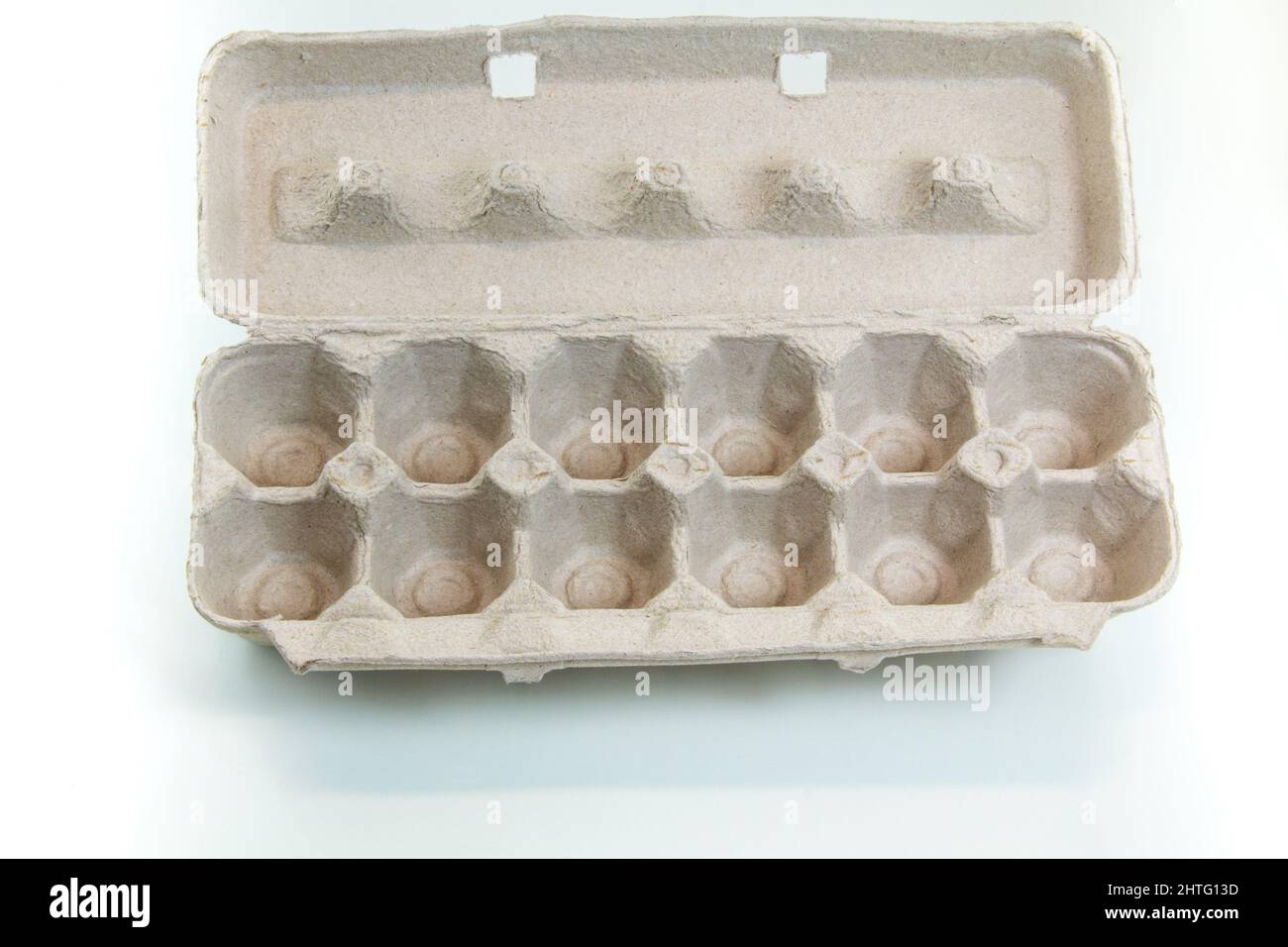 Empty, open eggs carton on a white background. Studio shot with copy ...