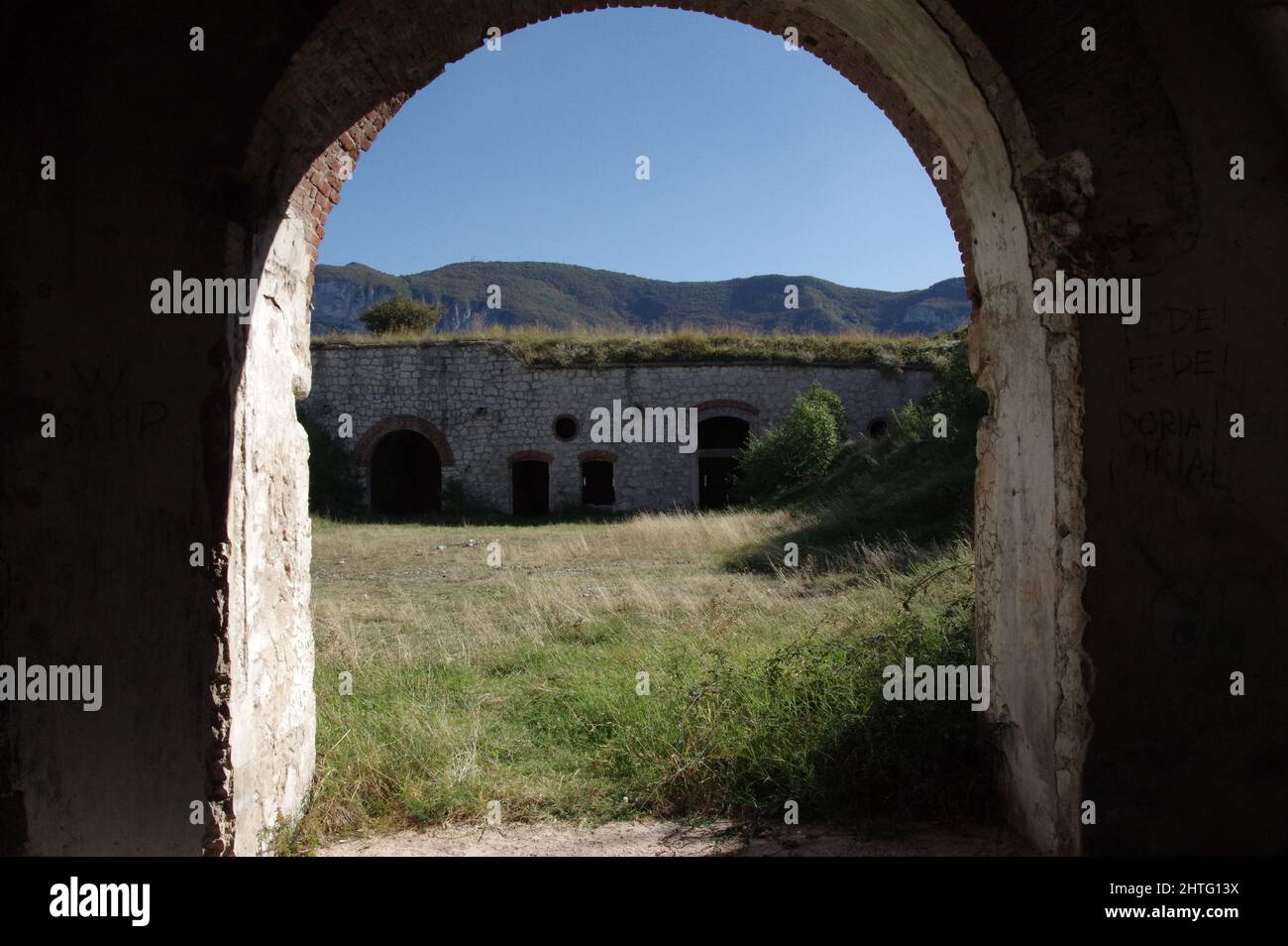 View through the arch of the abandoned World War 1 fortress overgrown ...