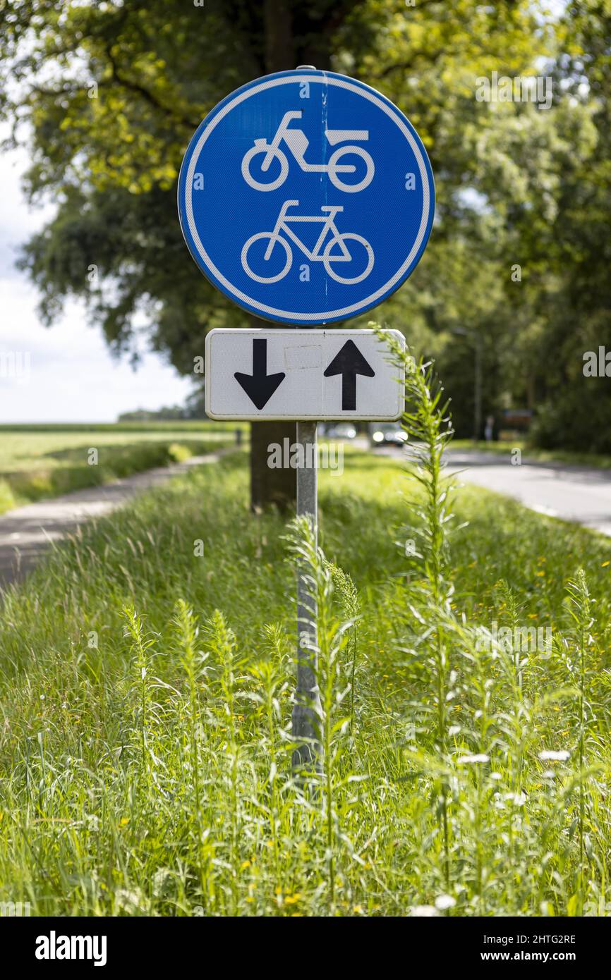 Traffic sign in berm along bike path and road Stock Photo - Alamy
