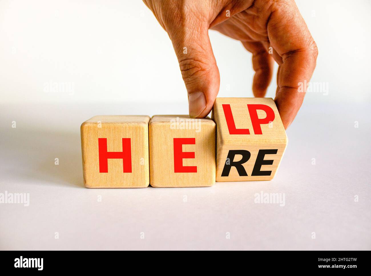 Help is here support symbol. Businessman turns the wooden cube and ...