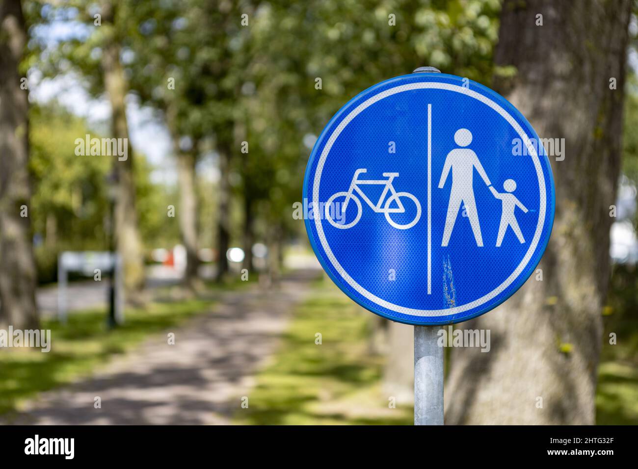 Walk and bike path with traffic sign Stock Photo - Alamy