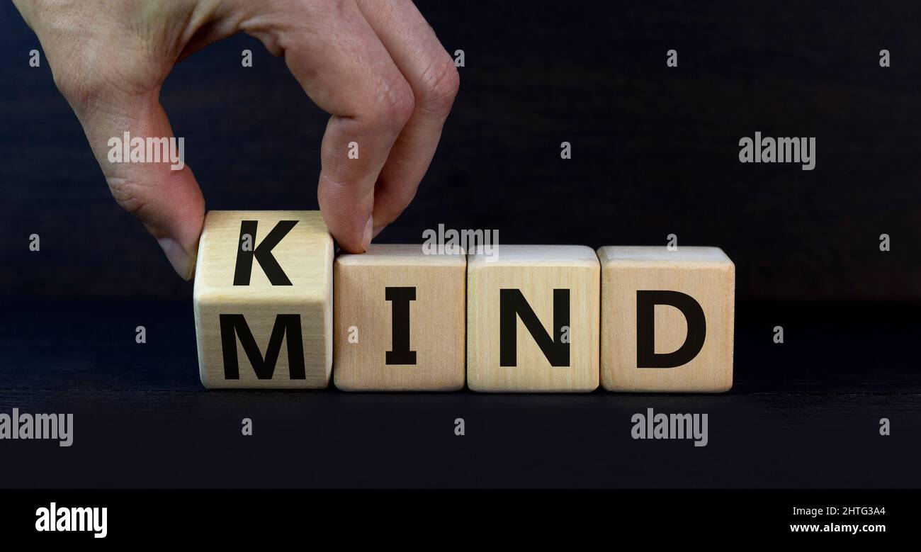 Have a kind mind. Businessman turnsa wooden cube and changes the word ...