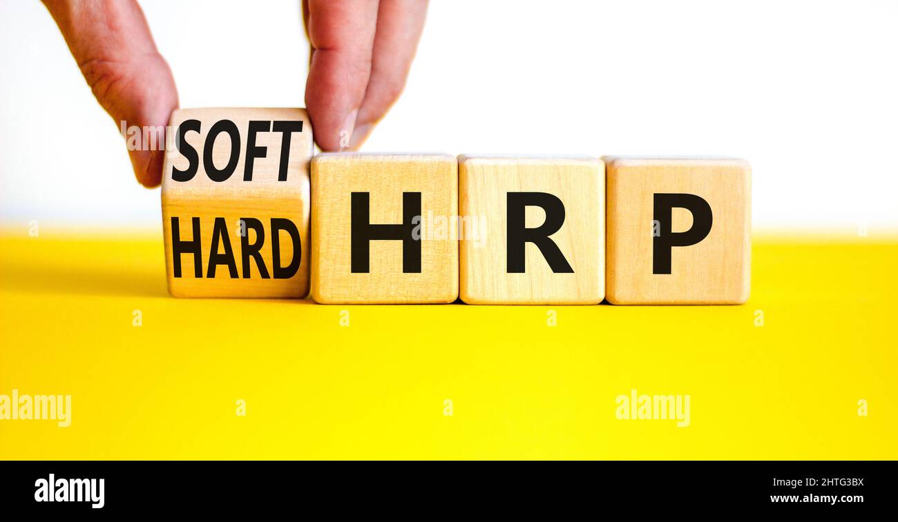 HRP, human resource planning symbol. Businessman turns a wooden cube ...