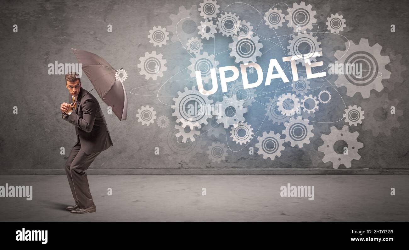 Businessman defending with umbrella concept Stock Photo - Alamy