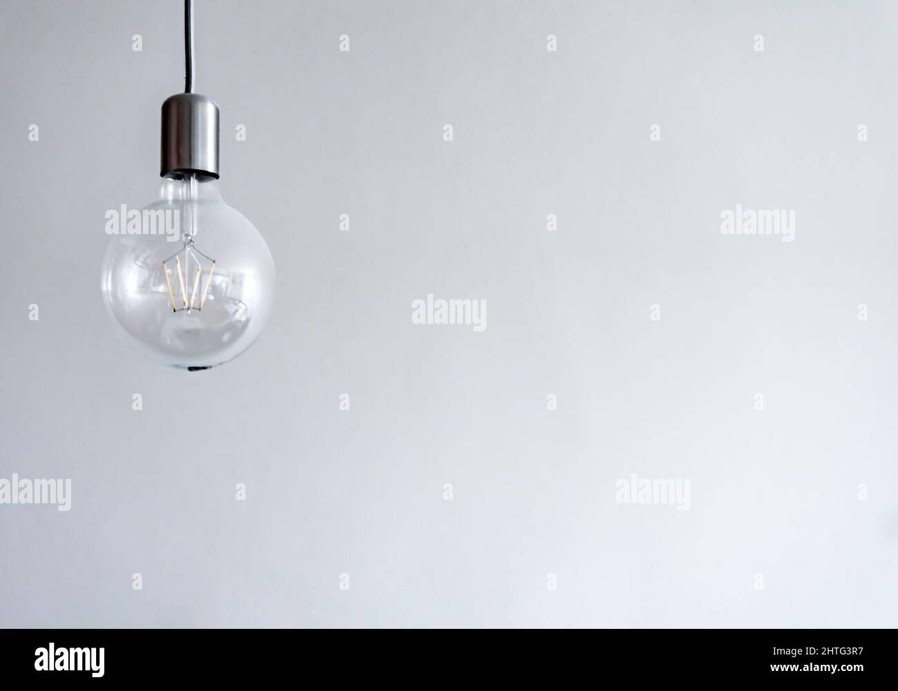 Retro big light bulb hanging on white background Stock Photo - Alamy