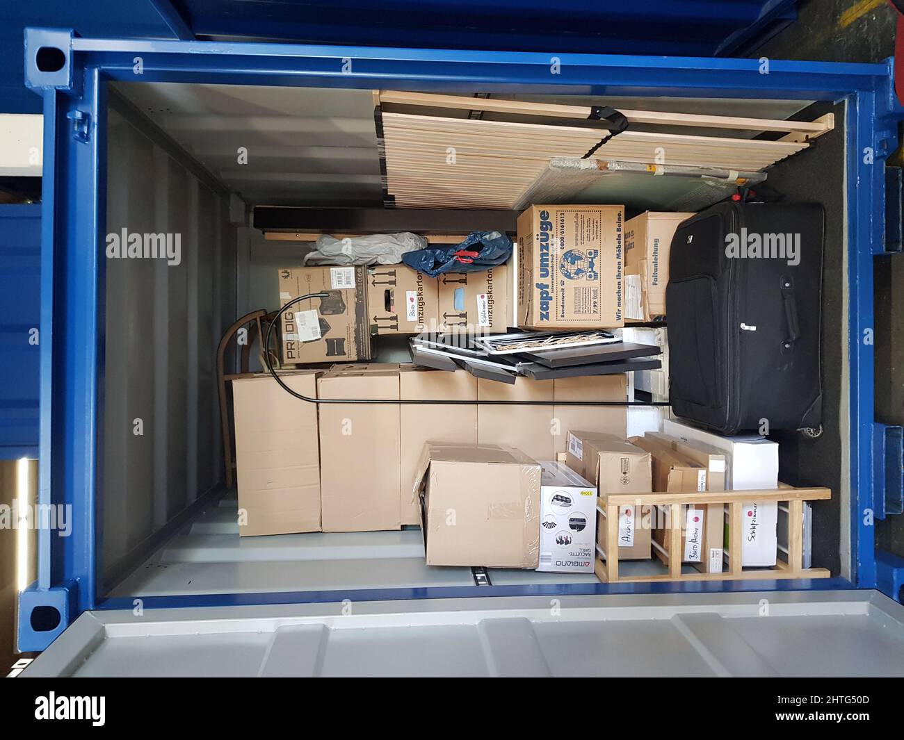 Vertical of a container full of cardboard boxes Stock Photo - Alamy