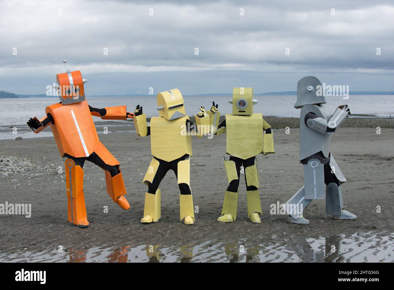 Colorful robots dancing, having fun on the beach. Robot friends ...