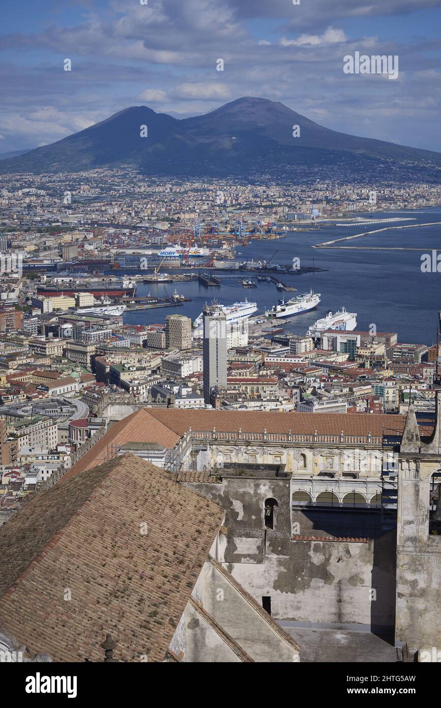 Vertical shot of the Mount Vesuvius surrounded by the sea and buildings ...