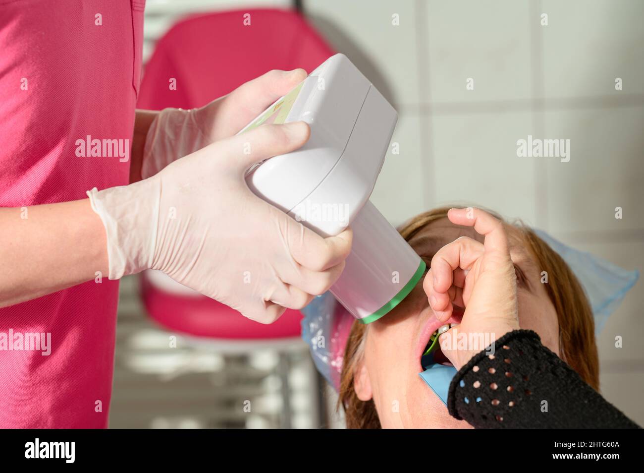 The dentist makes an X-ray of the client's tooth in the dentist's ...
