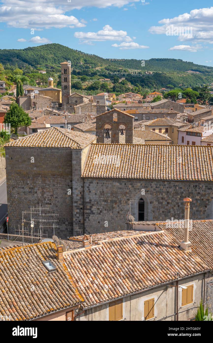Houses with tiled roofs of Onano under a blue cloudy sky on a sunny day ...