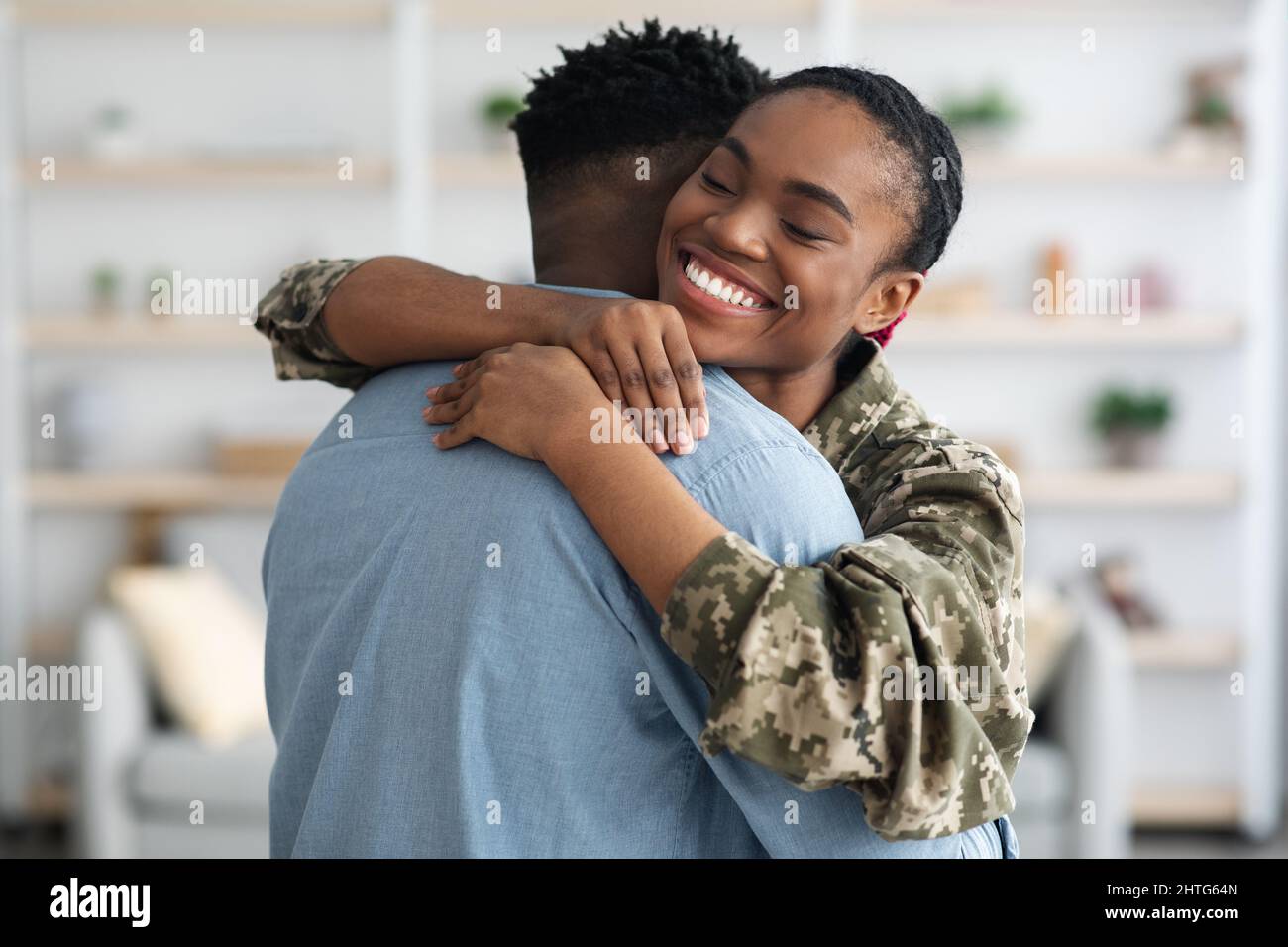 Closeup of cheerful black female soldier hugging her boyfriend Stock ...