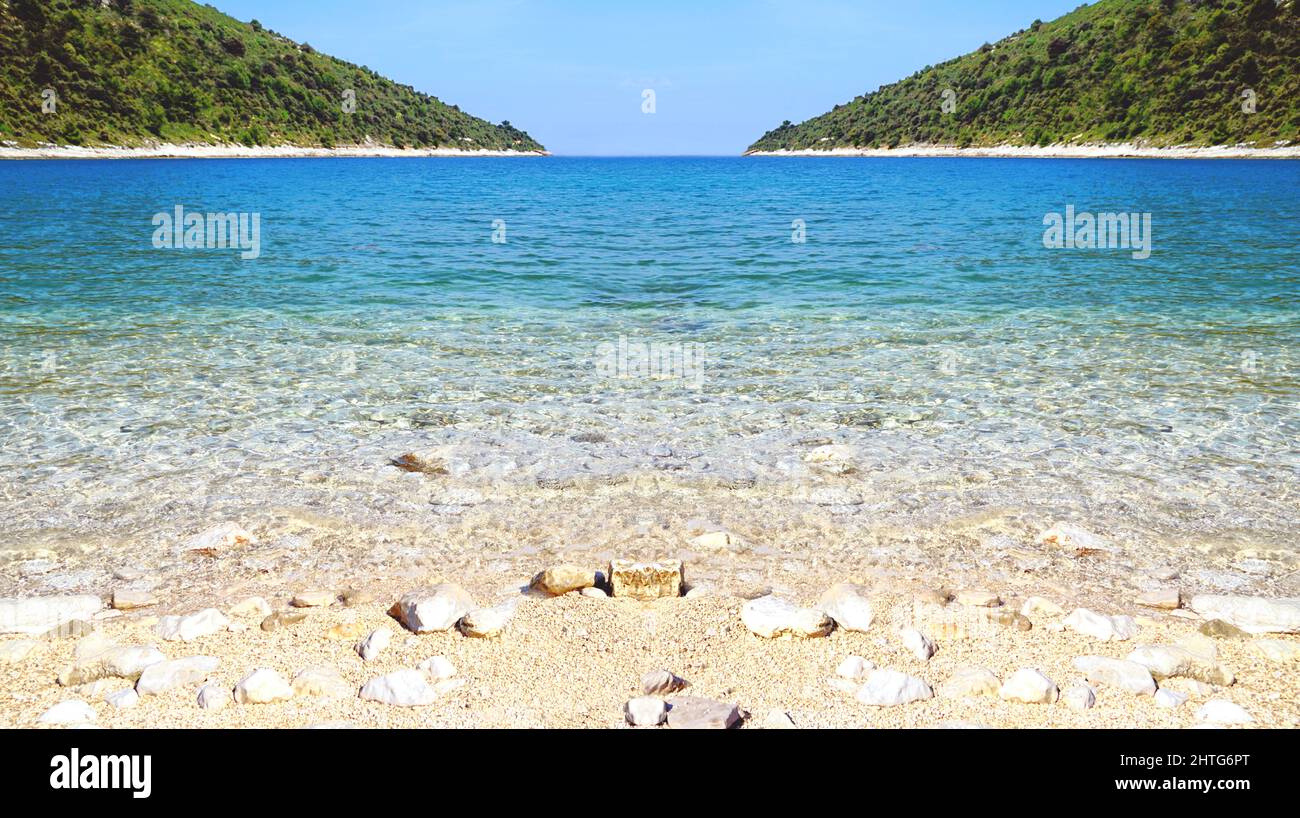 Abstract view of pebble beach in silver reflection in a beautiful blue ...