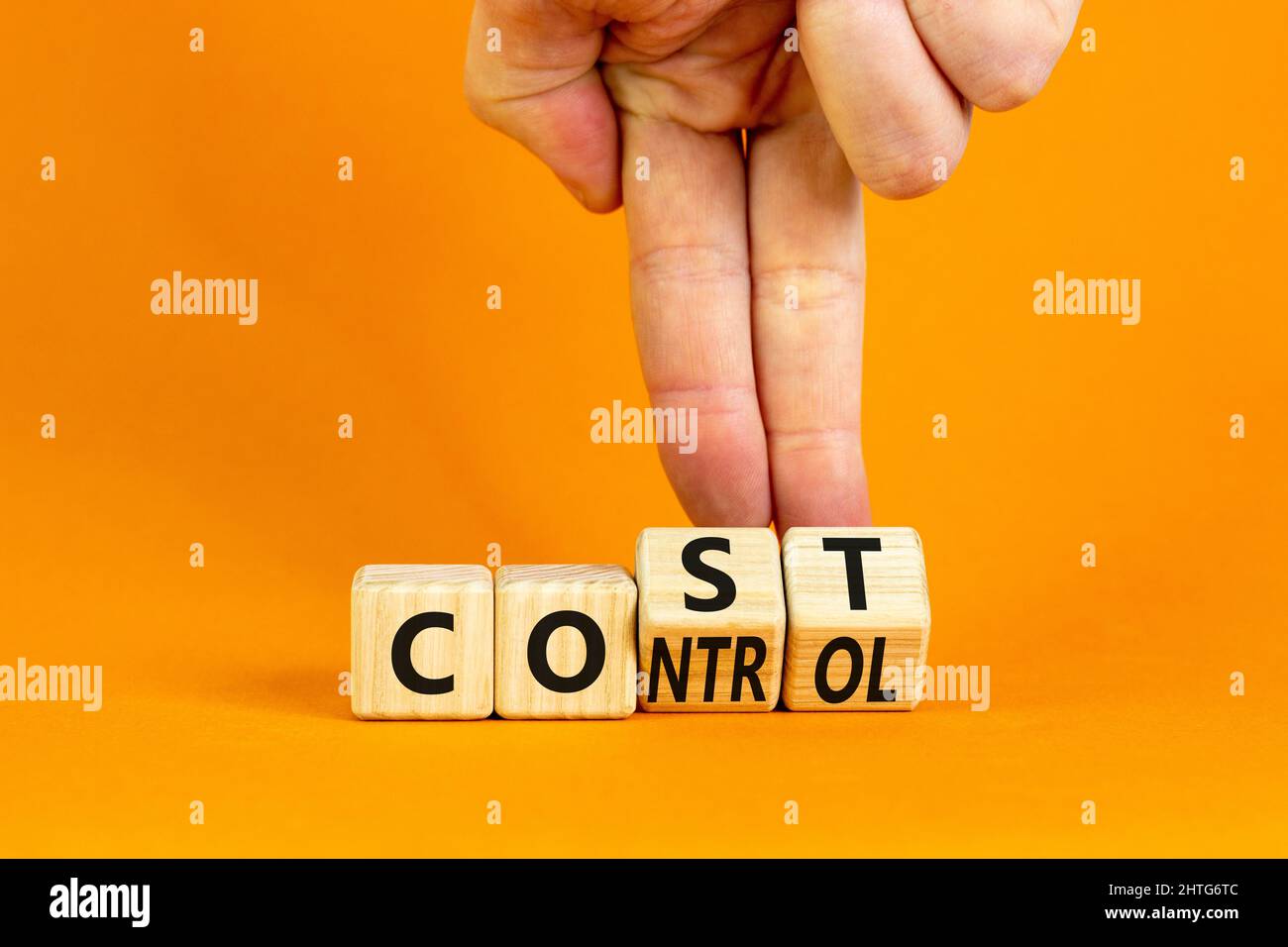 Cost control symbol. Businessman turns wooden cubes and changes the ...