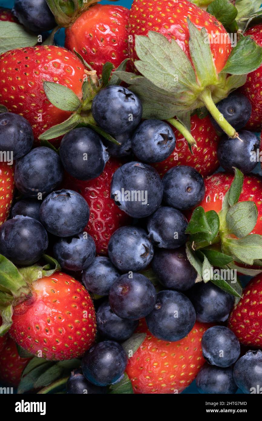 Full frame shot of fresh strawberries with blueberries, copy space ...