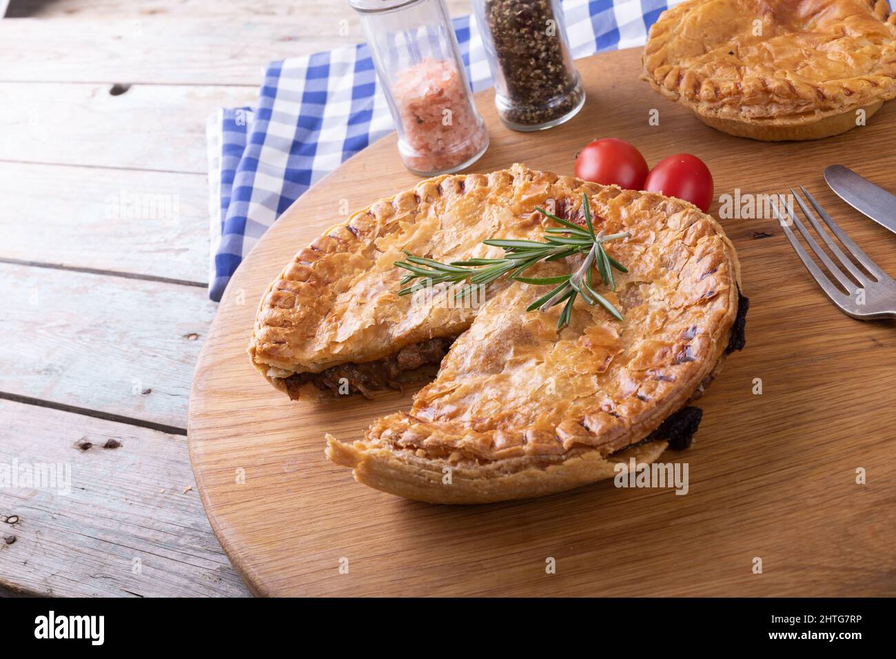 High angle close-up of baked stuffed pies with rosemary served on ...