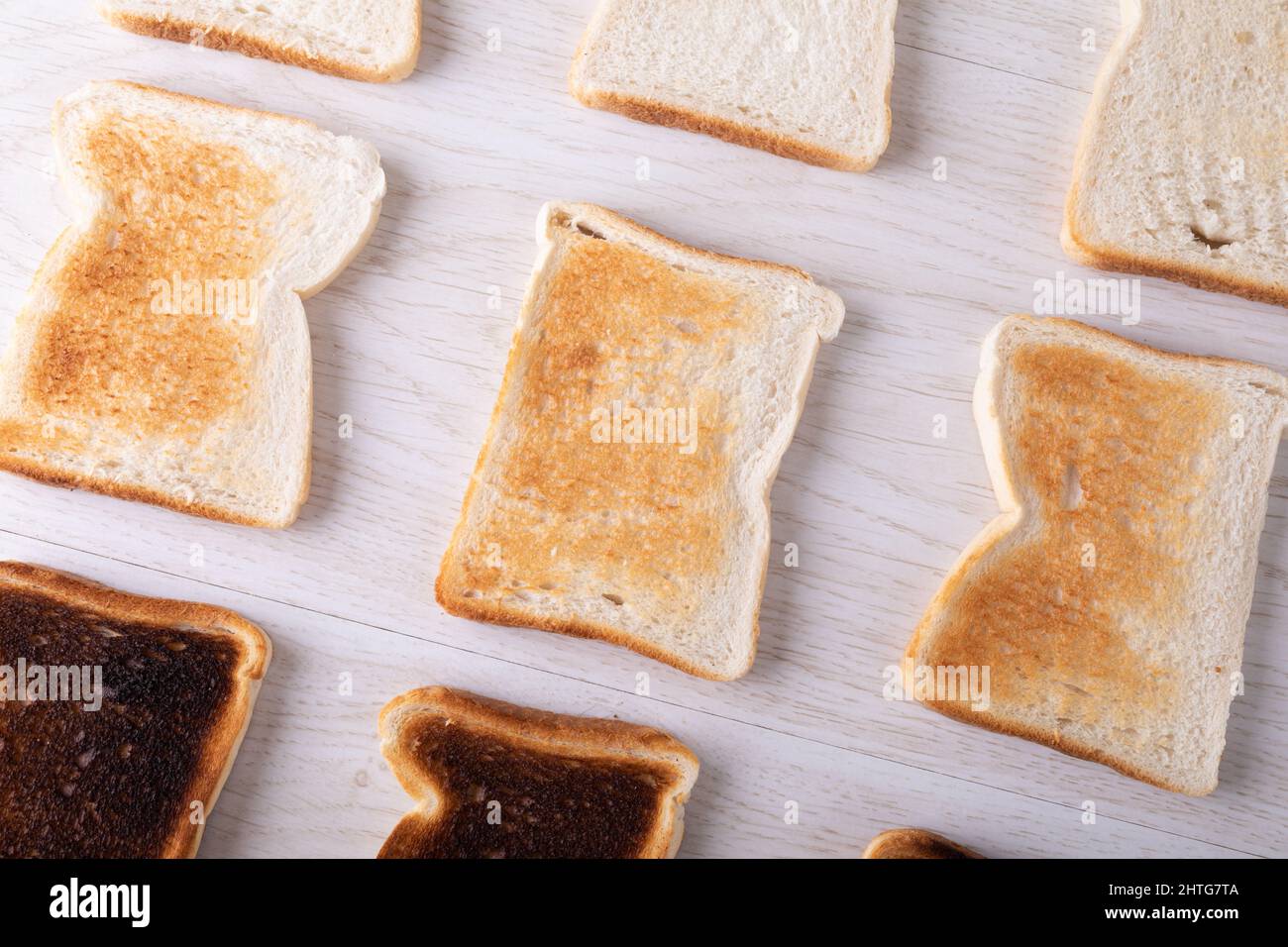 Full frame shot of toasted and burnt bread slices on table with copy ...