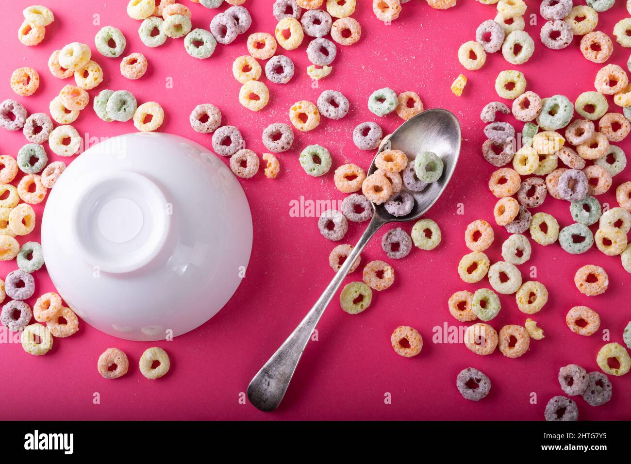 Close-up of upside down bowl and spoon with ring shaped breakfast ...