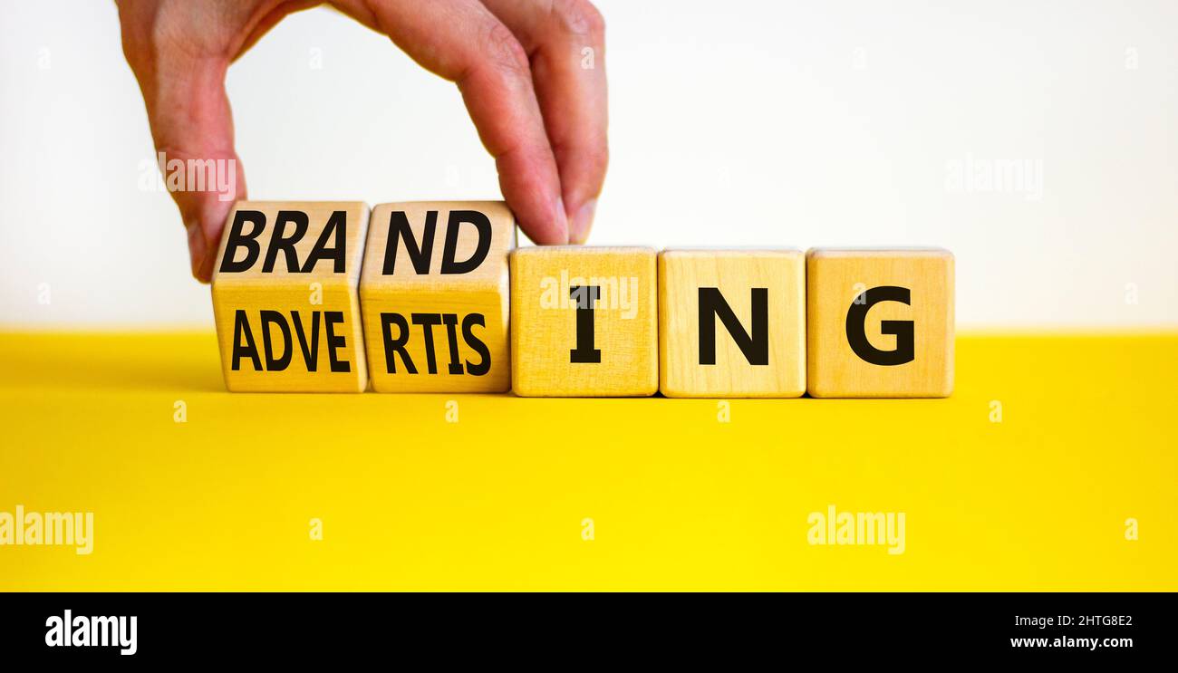 Branding and advertising symbol. Businessman turns wooden cubes and ...