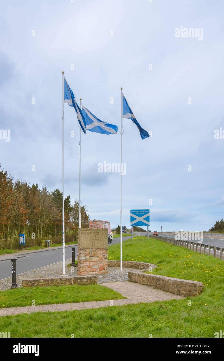 Flags of Scotland on the roadside against a cloudy sky Stock Photo - Alamy