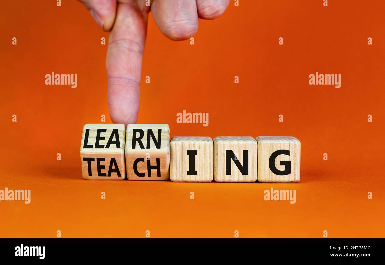 Learning or teaching symbol. Businessman turns wooden cubes and changes ...