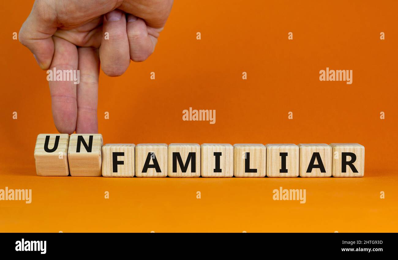 Familiar or unfamiliar symbol. Businessman turns wooden cubes changes ...