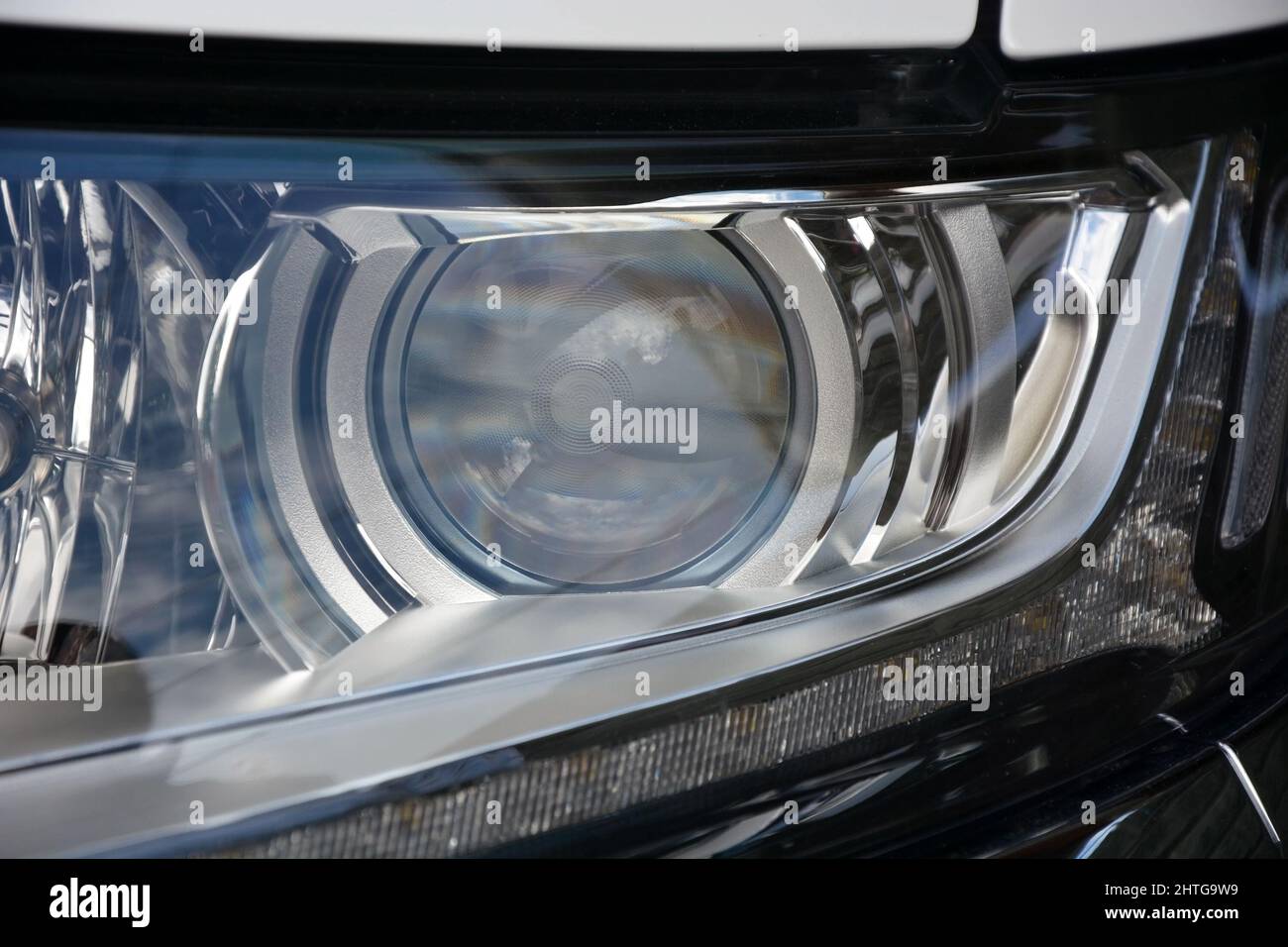 New headlight of a modern car close up. Photo can be used as a ...