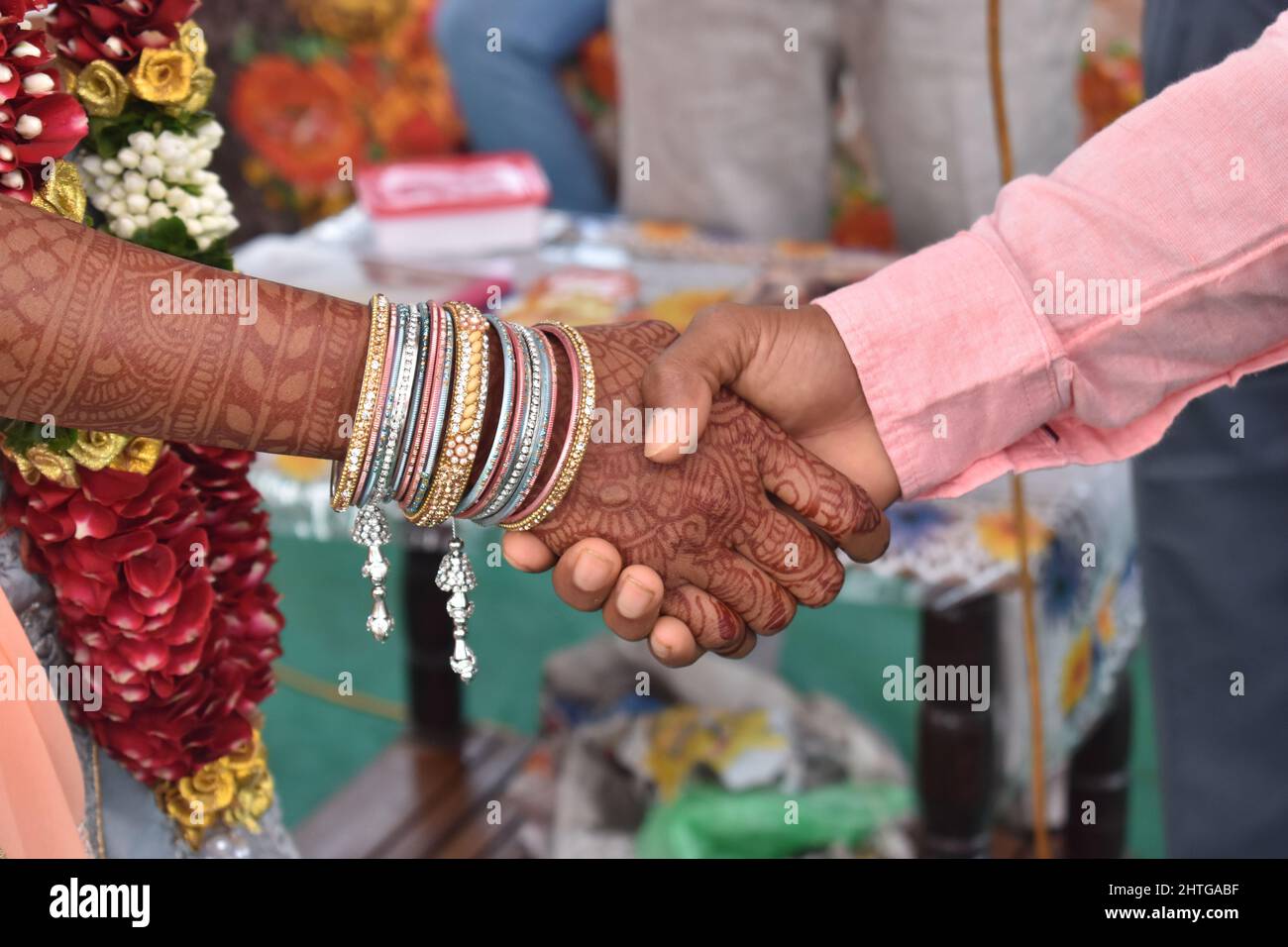 Closeup shot of the Indian couple's hands holding, during their wedding ...