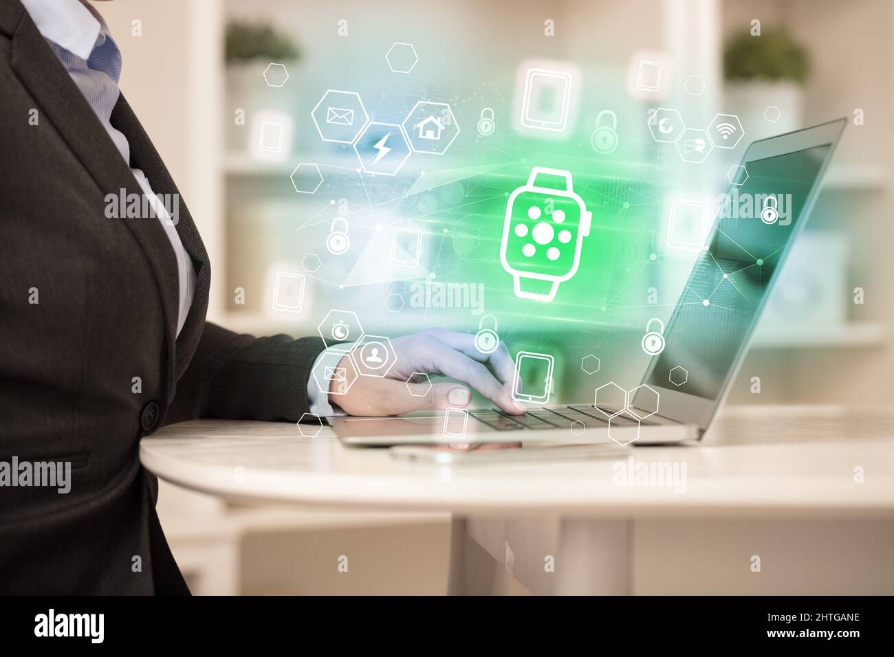 Hands working on laptop with digital icons Stock Photo - Alamy
