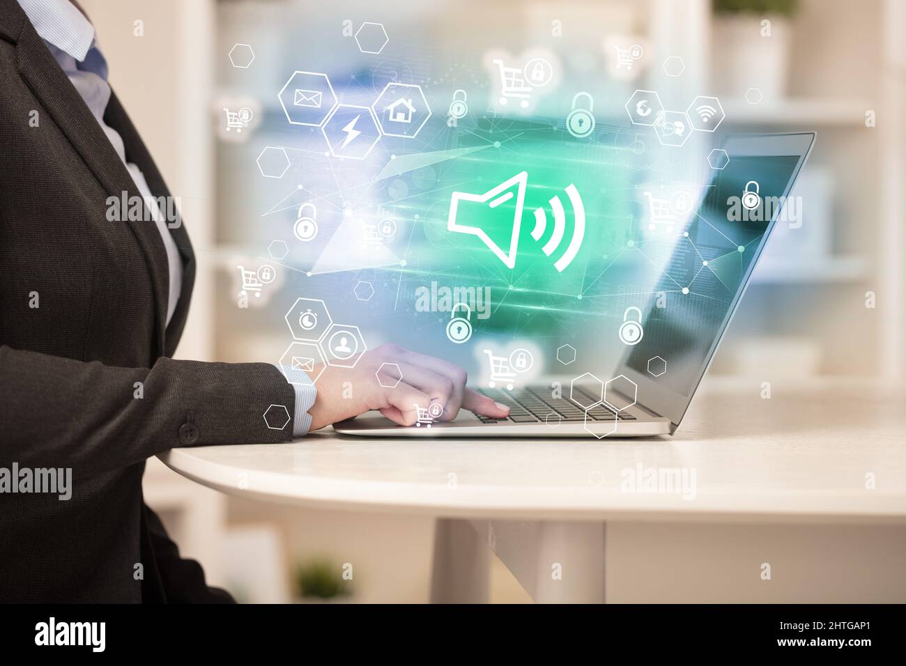 Hands working on laptop with digital icons Stock Photo - Alamy