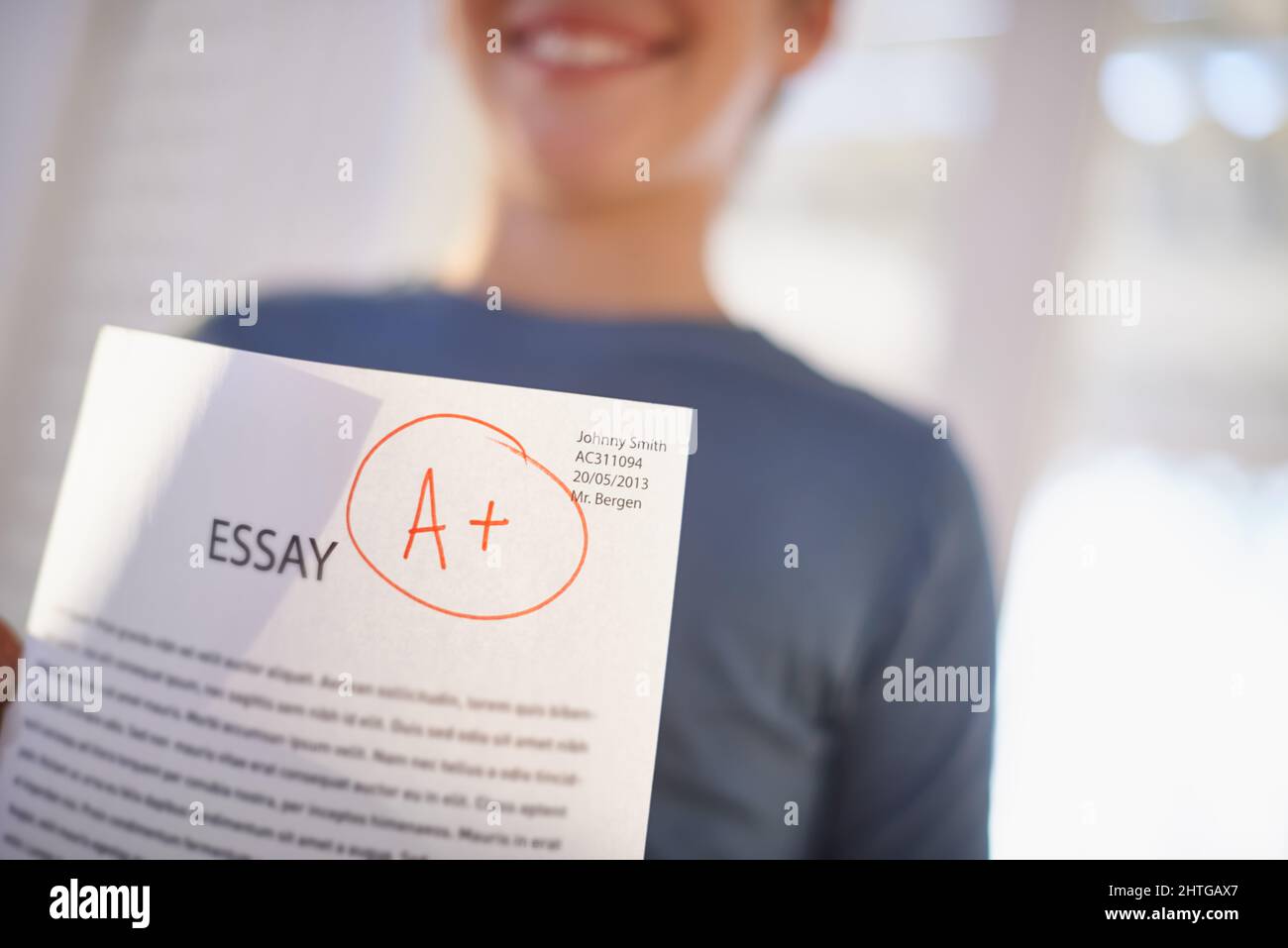 Easy A. Shot of a proud young boy holding up his essay that got him an ...