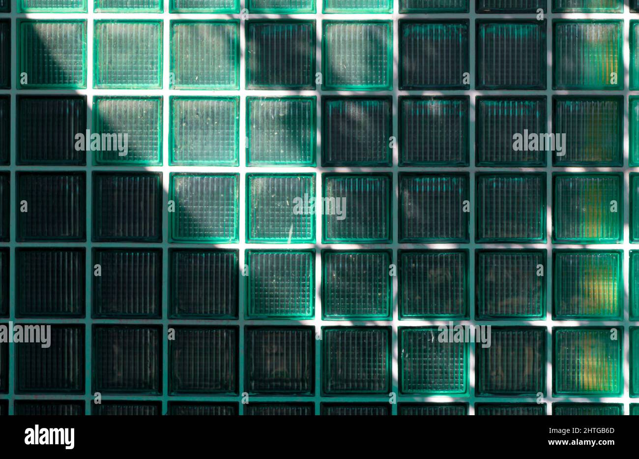 green symmetrical window pattern. Background with sunlight. Order. Wall ...