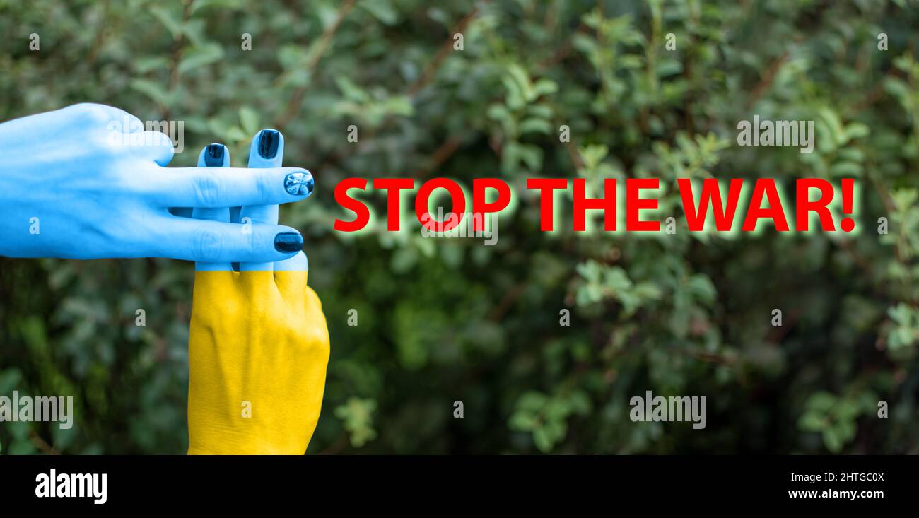 Stop war. Hashtag made from fingers. The color of the Ukrainian flag ...