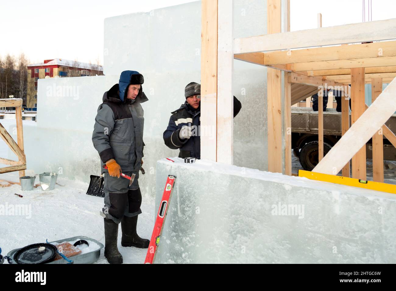Two workers assemble the slide frame from wooden beams Stock Photo - Alamy