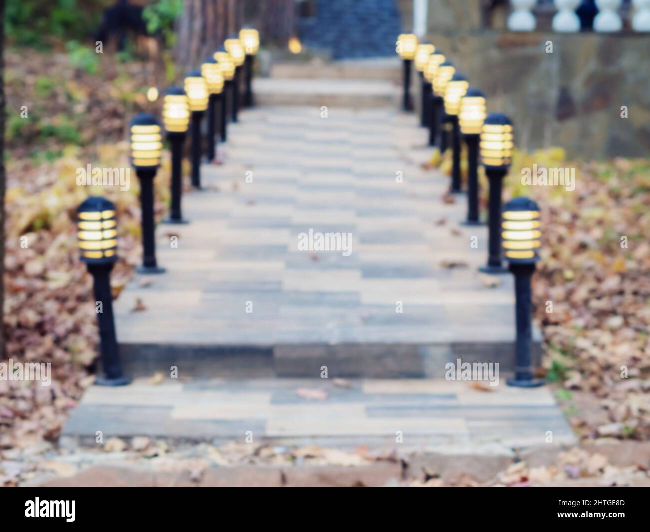 Low street lights are located along tiled walkway with steps in the ...