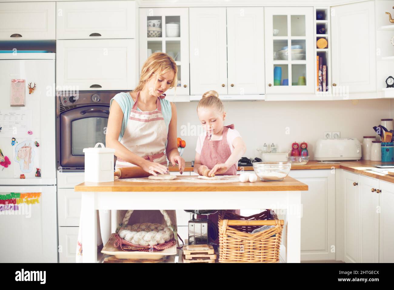 Working together to bake something delicious. Cute little girl baking ...