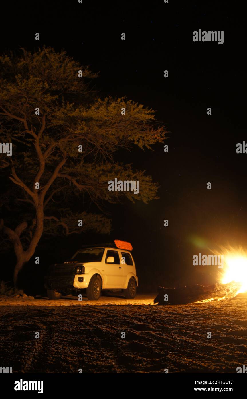 View of a car and a bonfire in a forest at night Stock Photo - Alamy