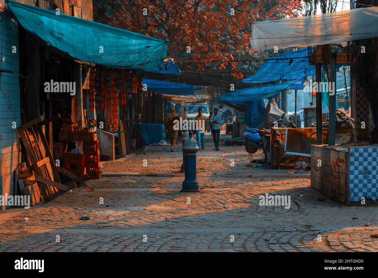 Street market with people walking on the street and shops open on the ...