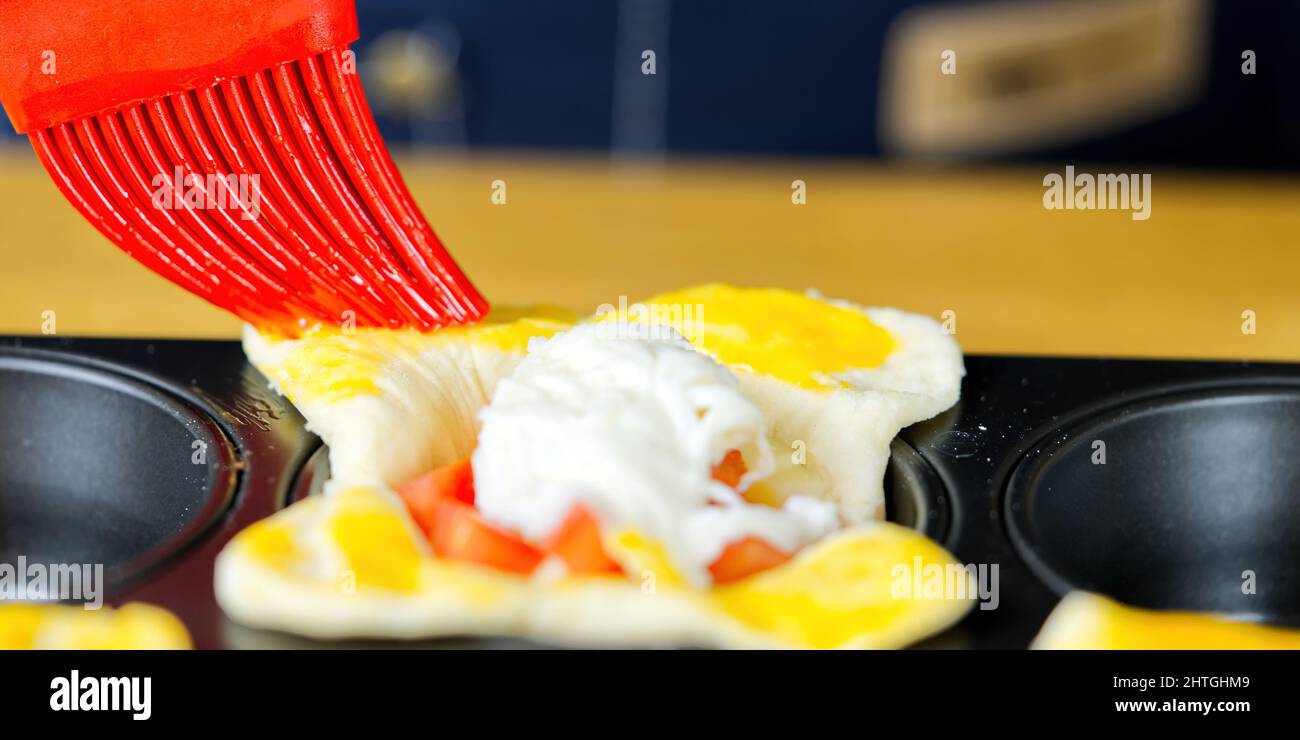 the chef oiling a puff pastry appetizers before baking in the oven ...