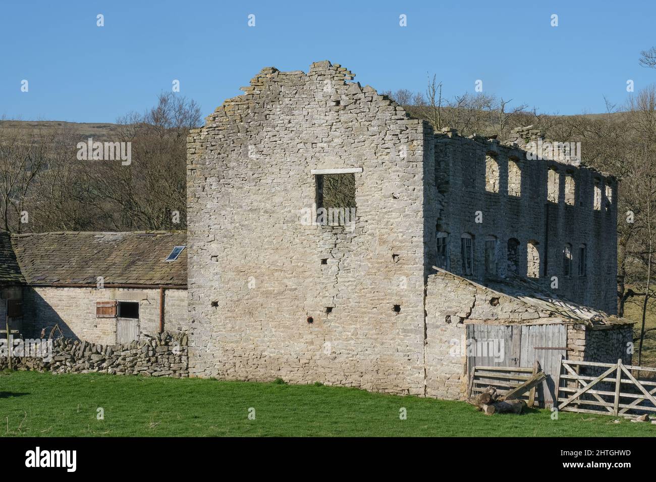 A huge, abandoned stone farm building on the edge of Castleton with ...